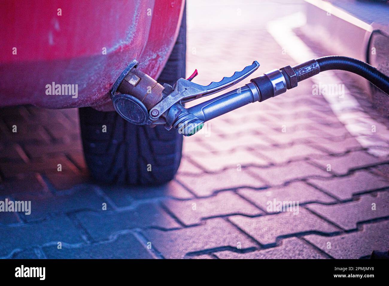refueling a car at a gas station at sunset, horizontal Stock Photo - Alamy