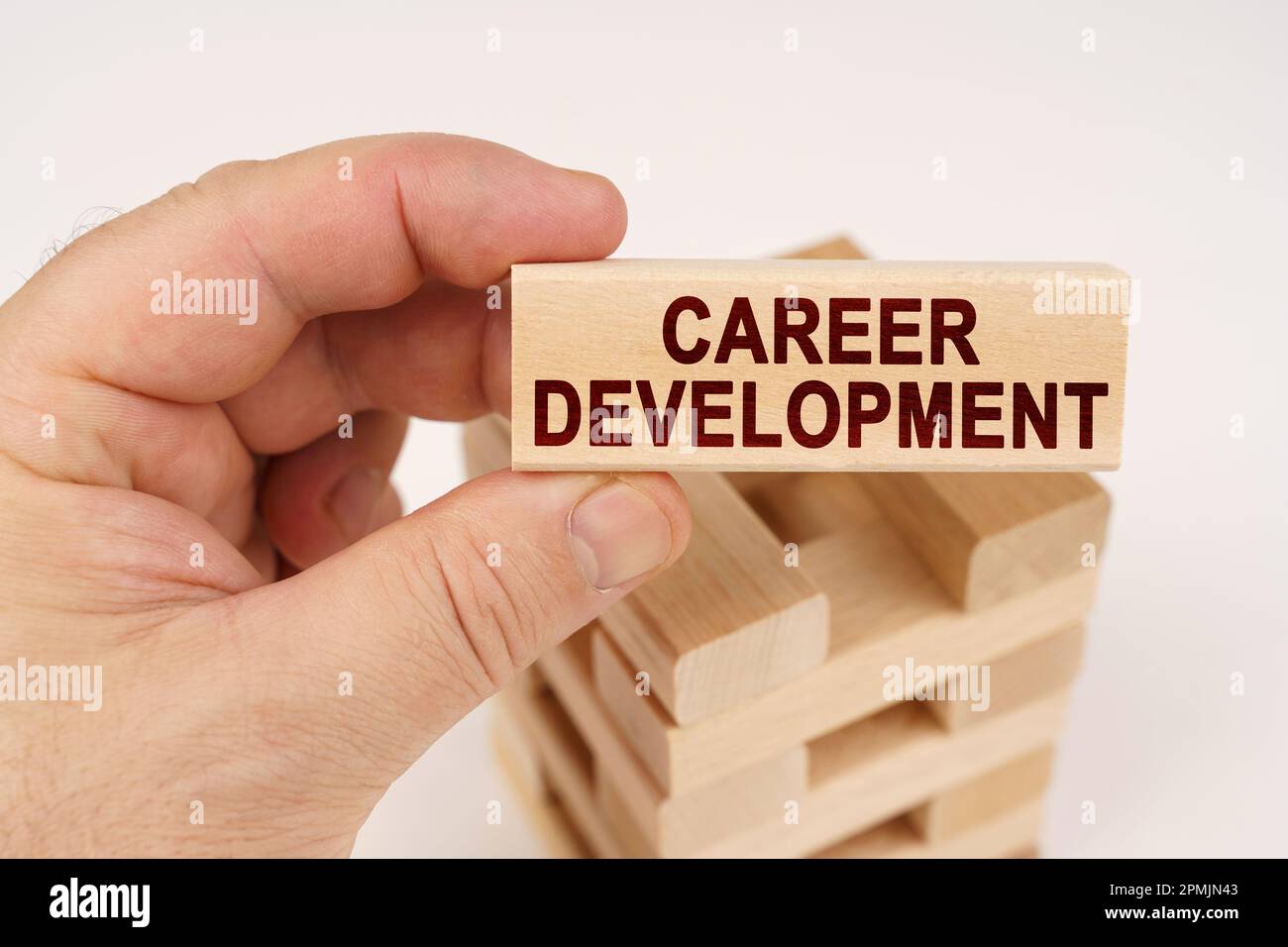 Business concept. A man holds in his hands a wooden block with the ...
