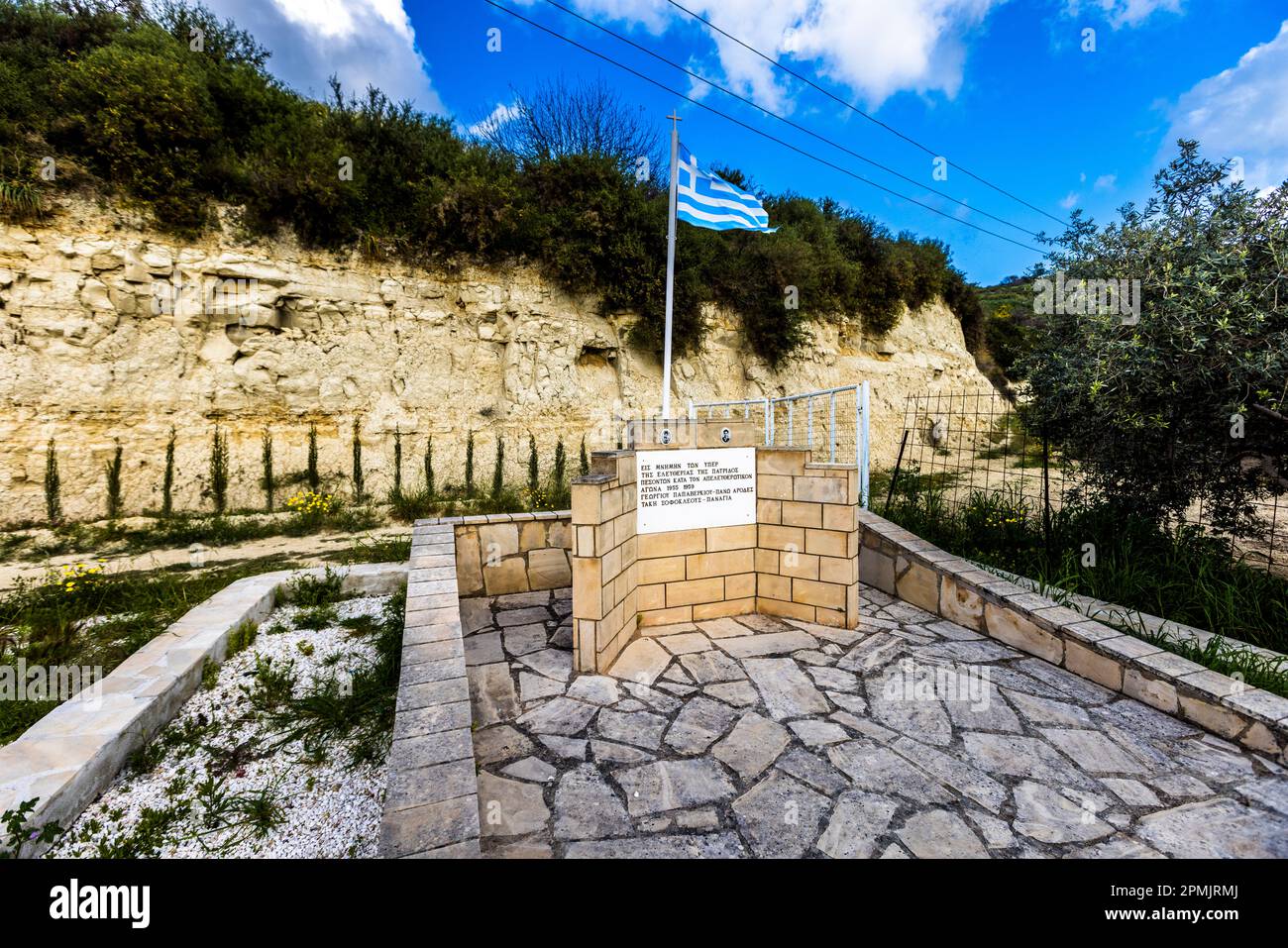A Greek flag flies over a war memorial commemorating fighting between ...