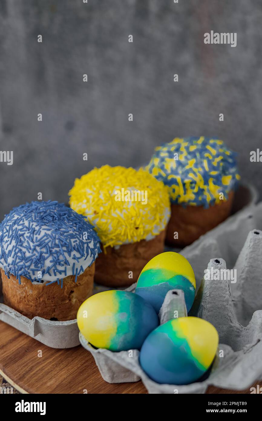 Easter cakes in the colors of the flag of Ukraine, yellow and blue in a ...