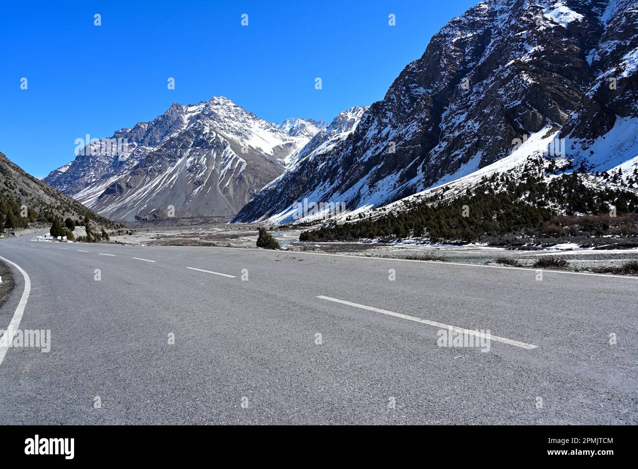 Snow filled grey mountain on the road ahead Stock Photo - Alamy