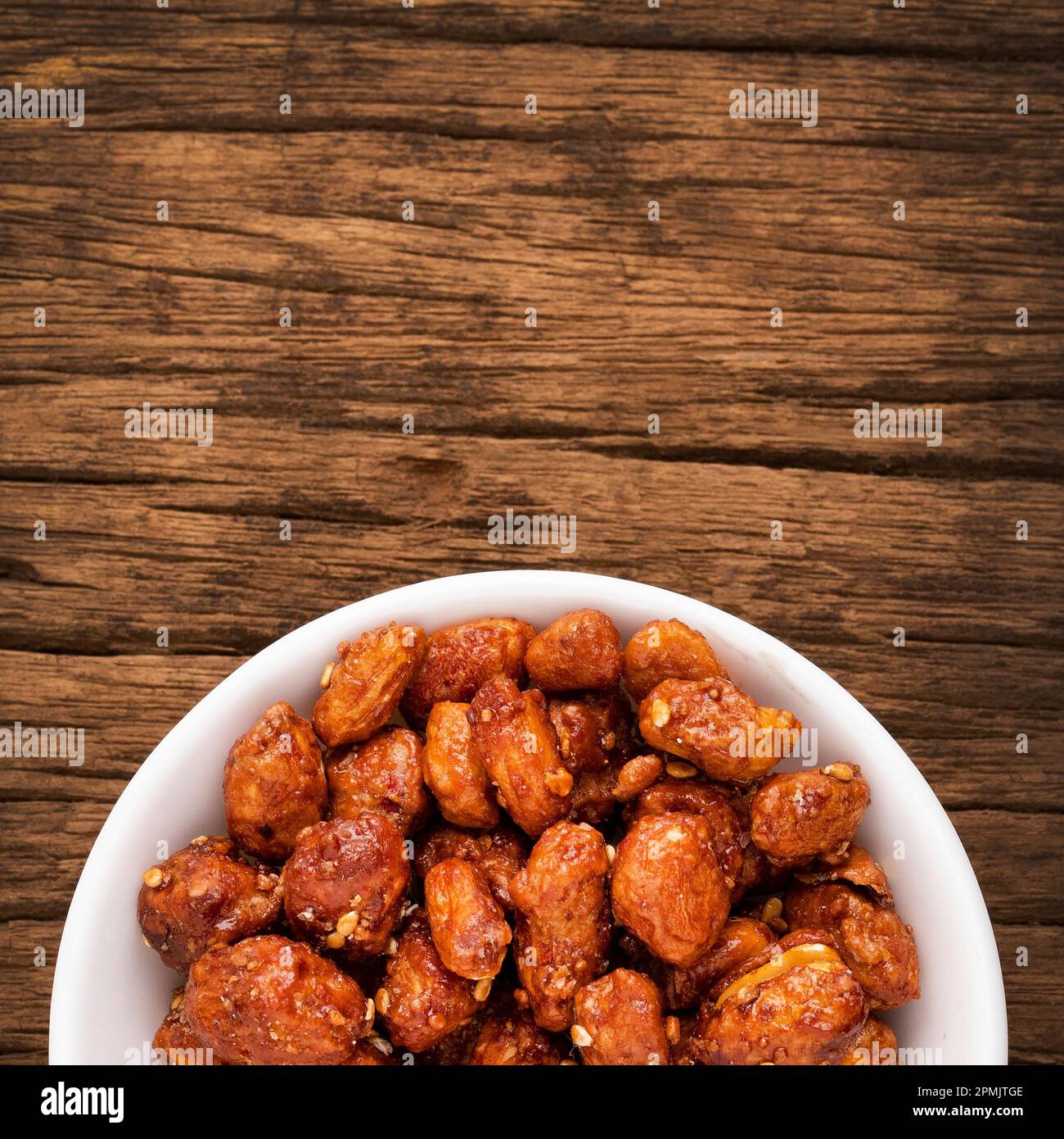 Roasted peanut with caramel coating and white sesame seeds - Arachis ...
