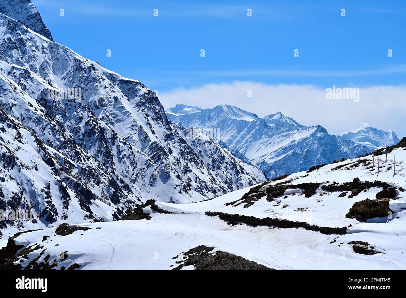 Black cascading mountains filled with snow Stock Photo - Alamy
