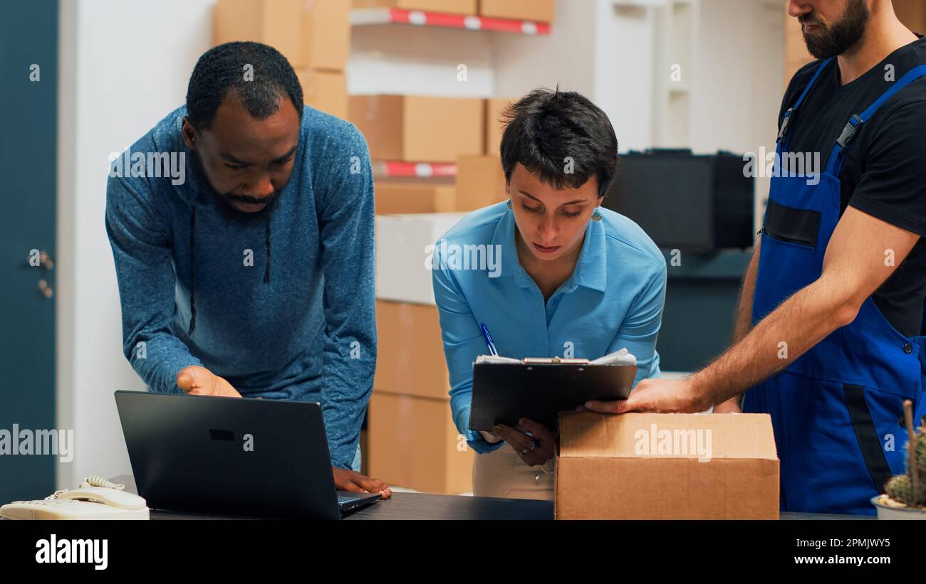 Diverse team of people checking supply chain on warehouse shelves ...