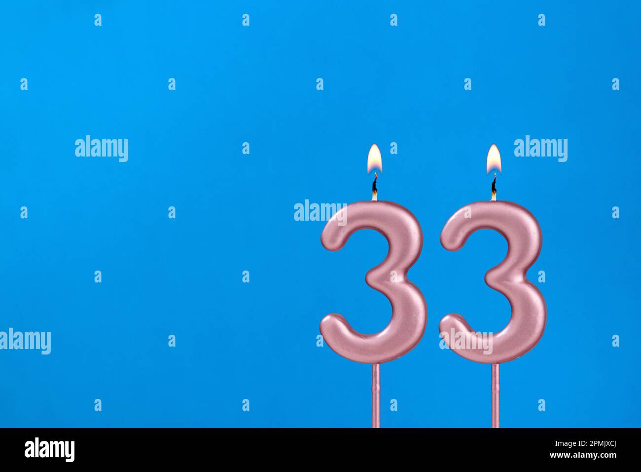 Candle number 33 - Birthday in blues foamy background Stock Photo - Alamy