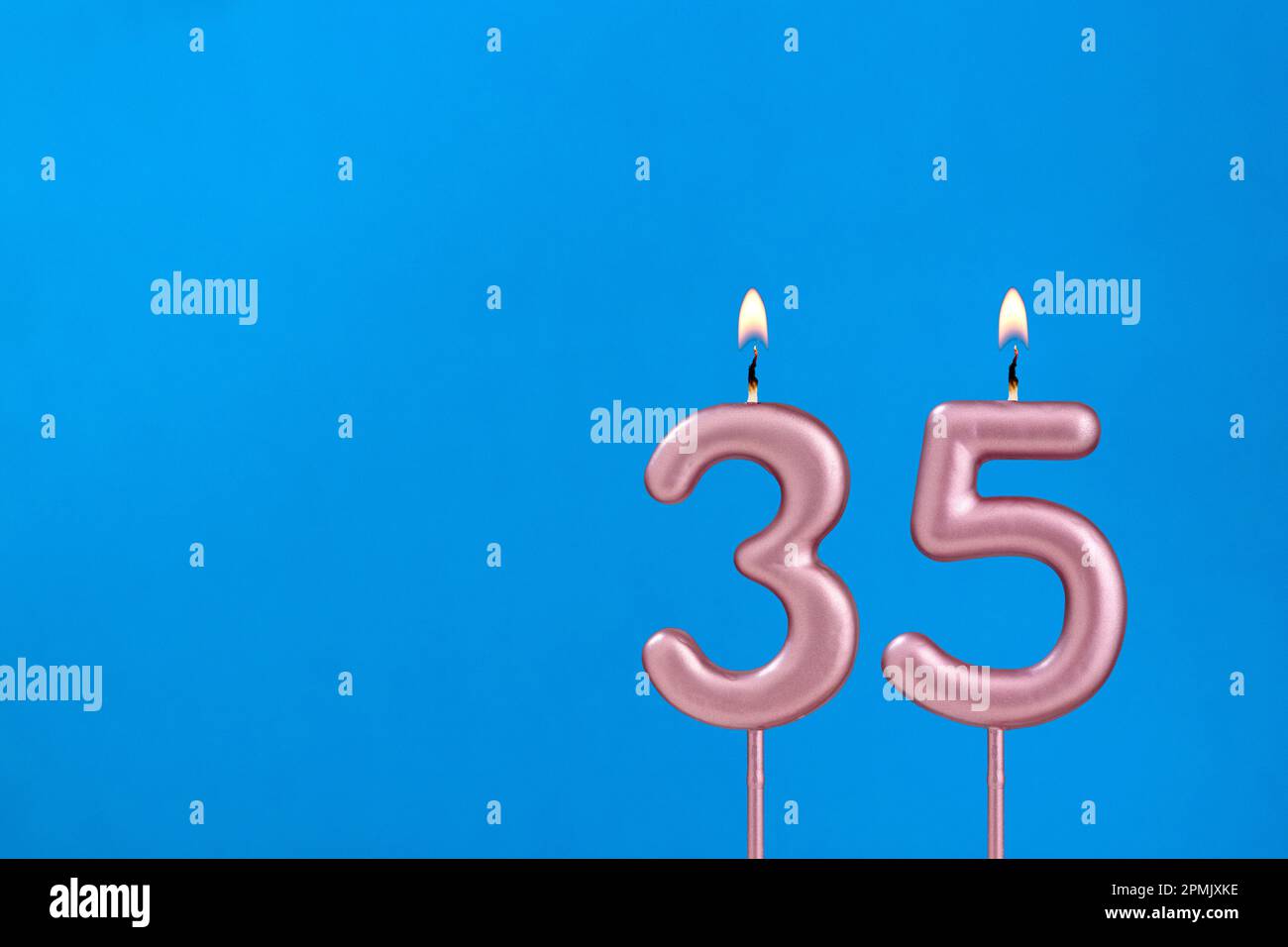 Candle number 35 - Birthday in blues foamy background Stock Photo - Alamy