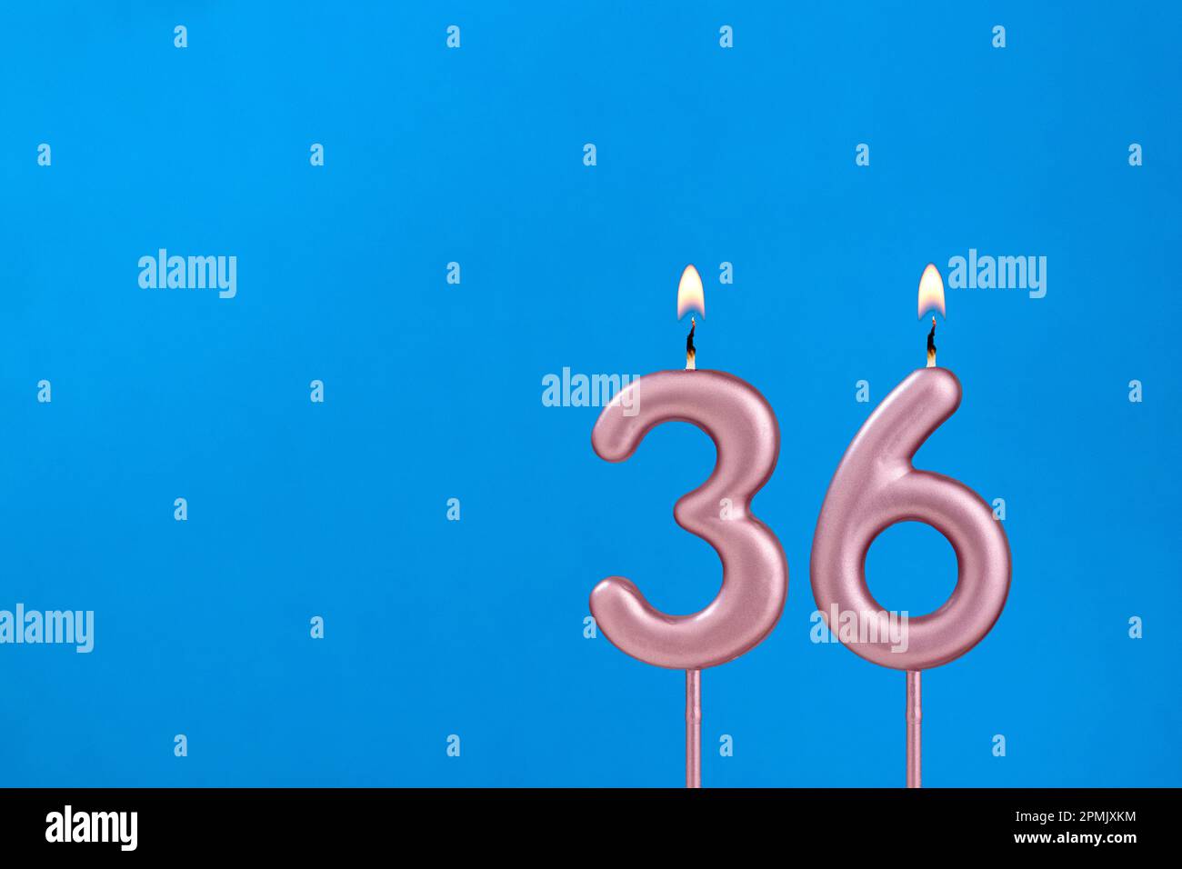 Number 36 - Burning anniversary candle on blue foamy background Stock ...
