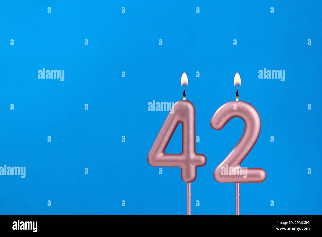 Candle number 42 - Birthday in blues foamy background Stock Photo - Alamy