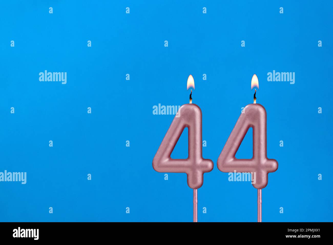 Candle number 44 - Birthday in blues foamy background Stock Photo - Alamy