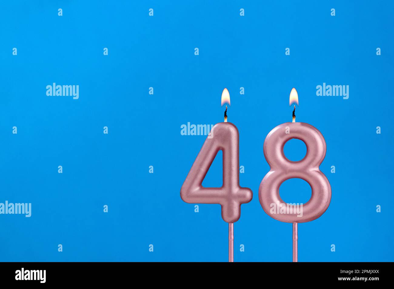 Candle number 48 - Birthday in blues foamy background Stock Photo - Alamy