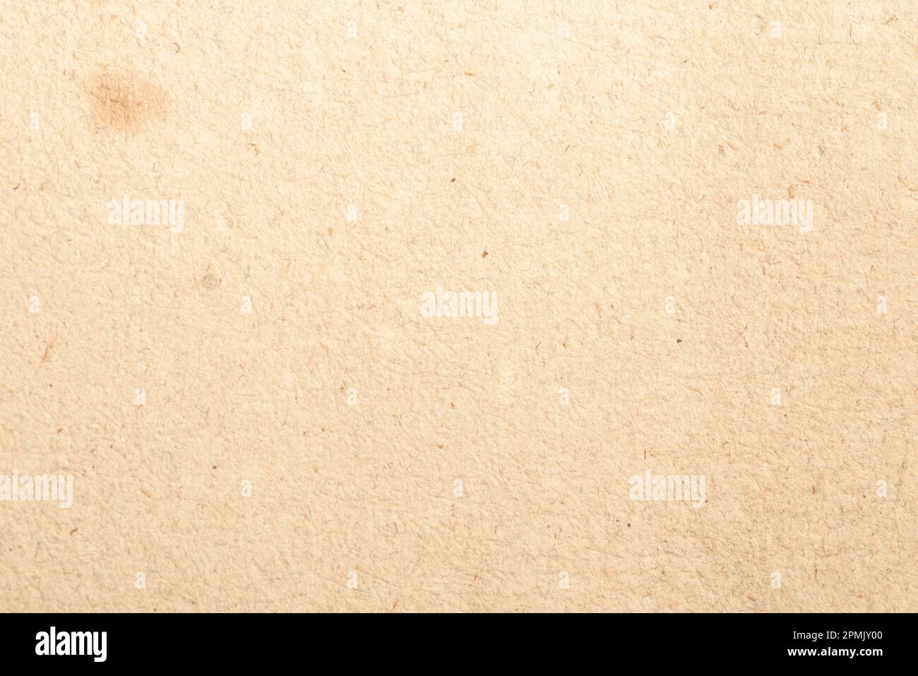 A brown paper background texture with visible dust particles scattered ...