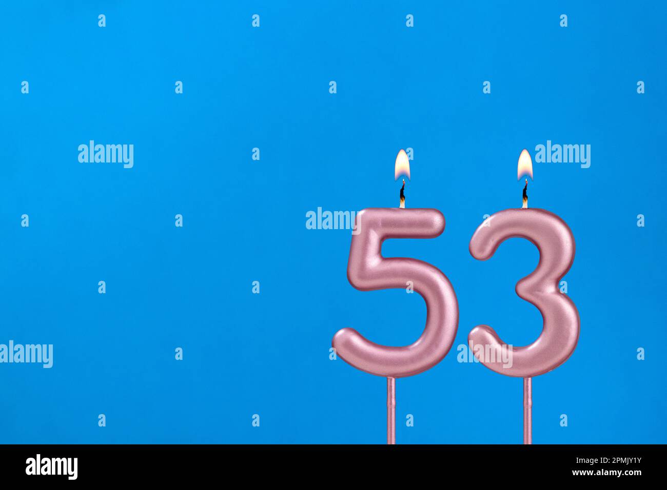Number 53 - Burning anniversary candle on blue foamy background Stock ...