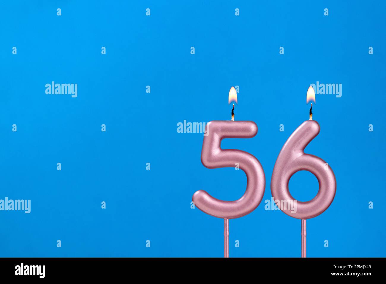 Candle number 56 - Birthday in blues foamy background Stock Photo - Alamy