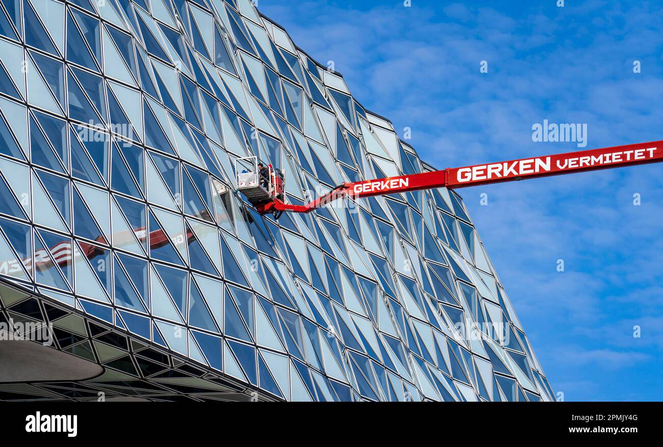 Building cleaners clean window panes, clean a facade, truck working ...