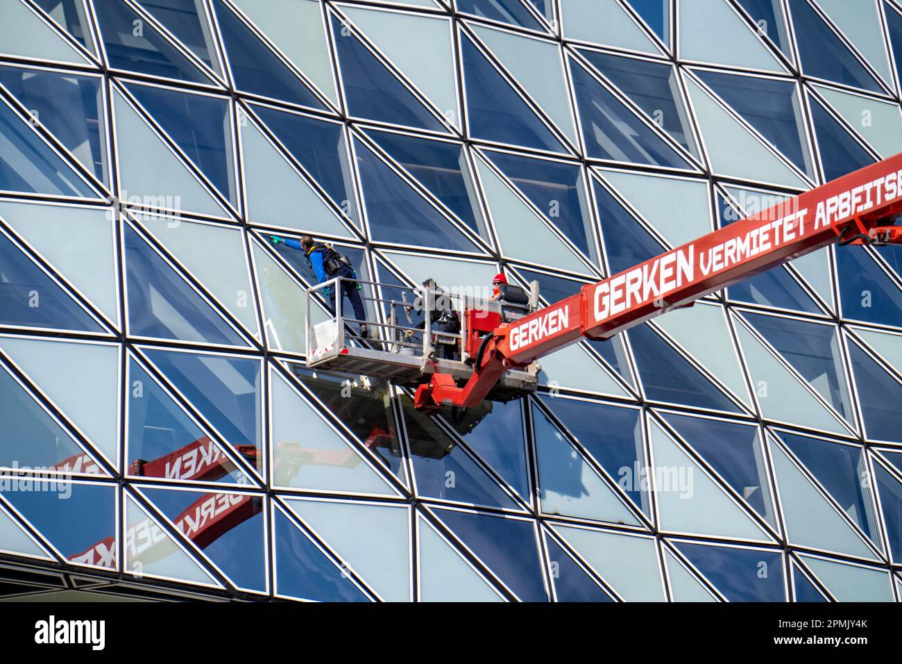 Building cleaners clean window panes, clean a facade, truck working ...