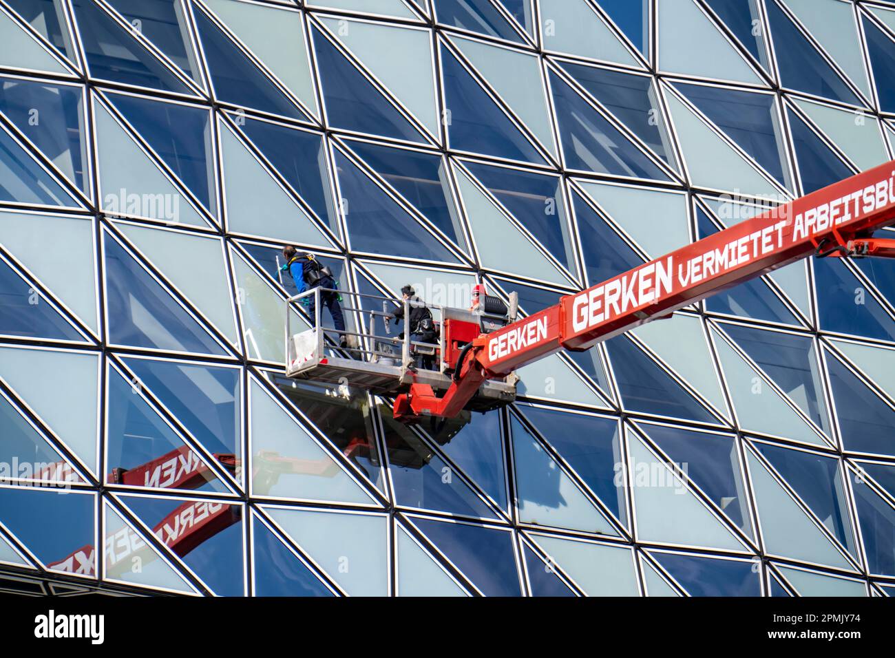Building cleaners clean window panes, clean a facade, truck working ...