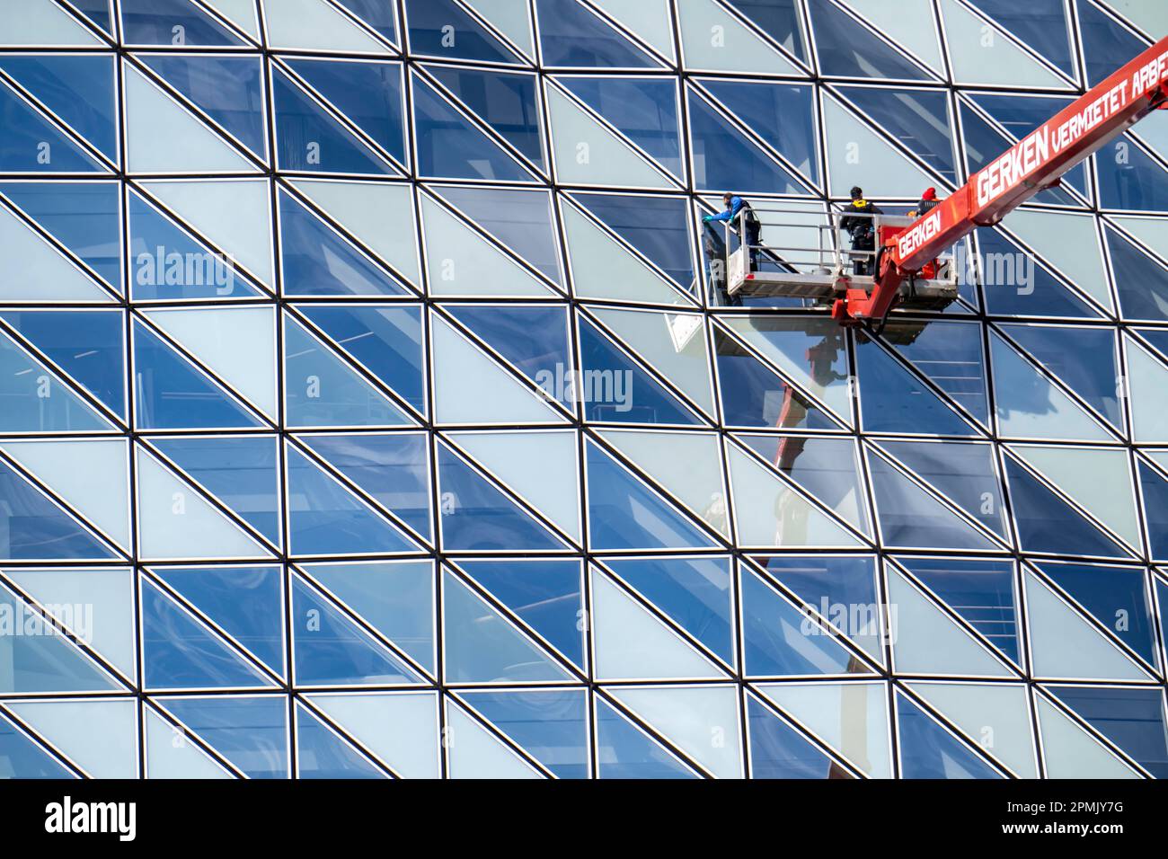 Building cleaners clean window panes, clean a facade, truck working ...