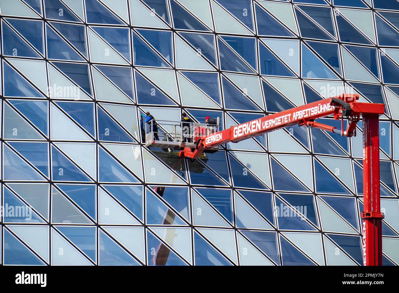 Building cleaners clean window panes, clean a facade, truck working ...