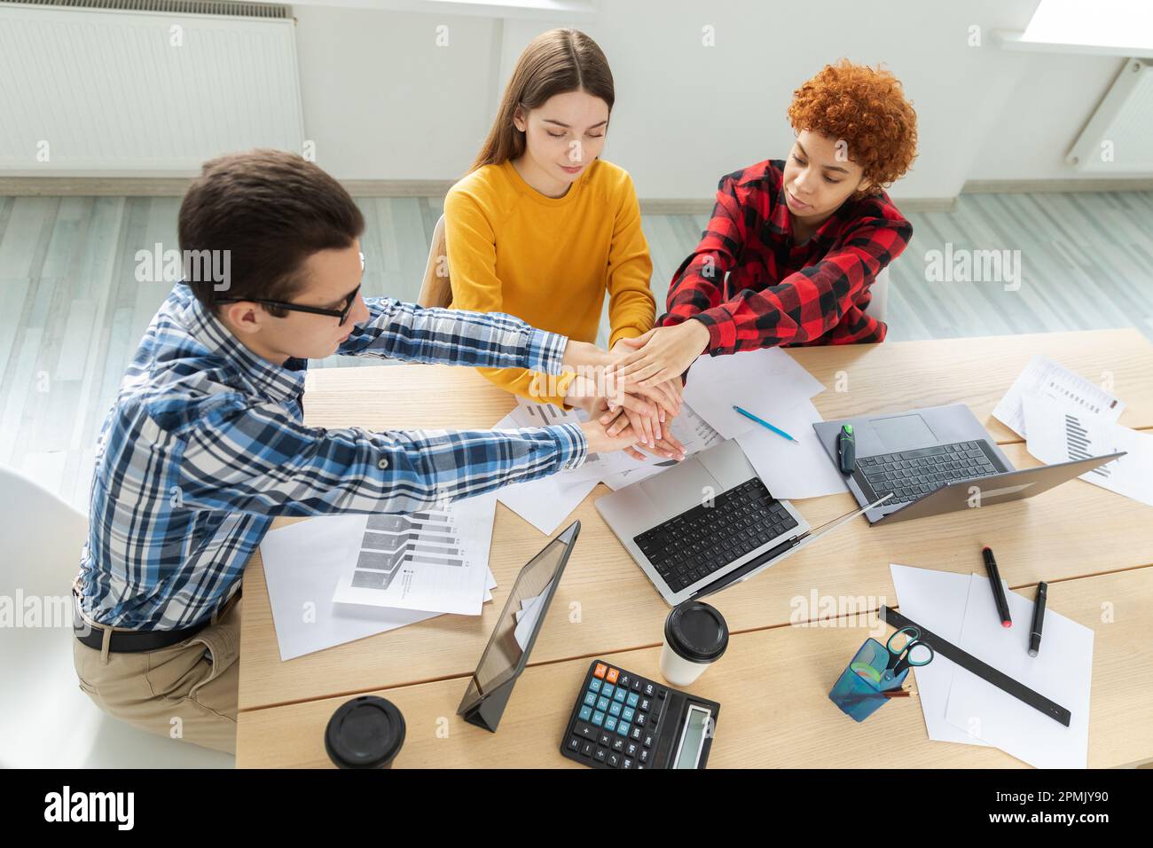 Stack of hands. Business startup teamwork unity concept. Top view of young business people ...