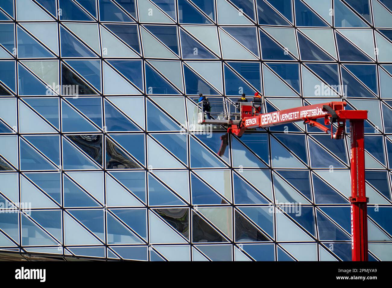 Building cleaners clean window panes, clean a facade, truck working ...