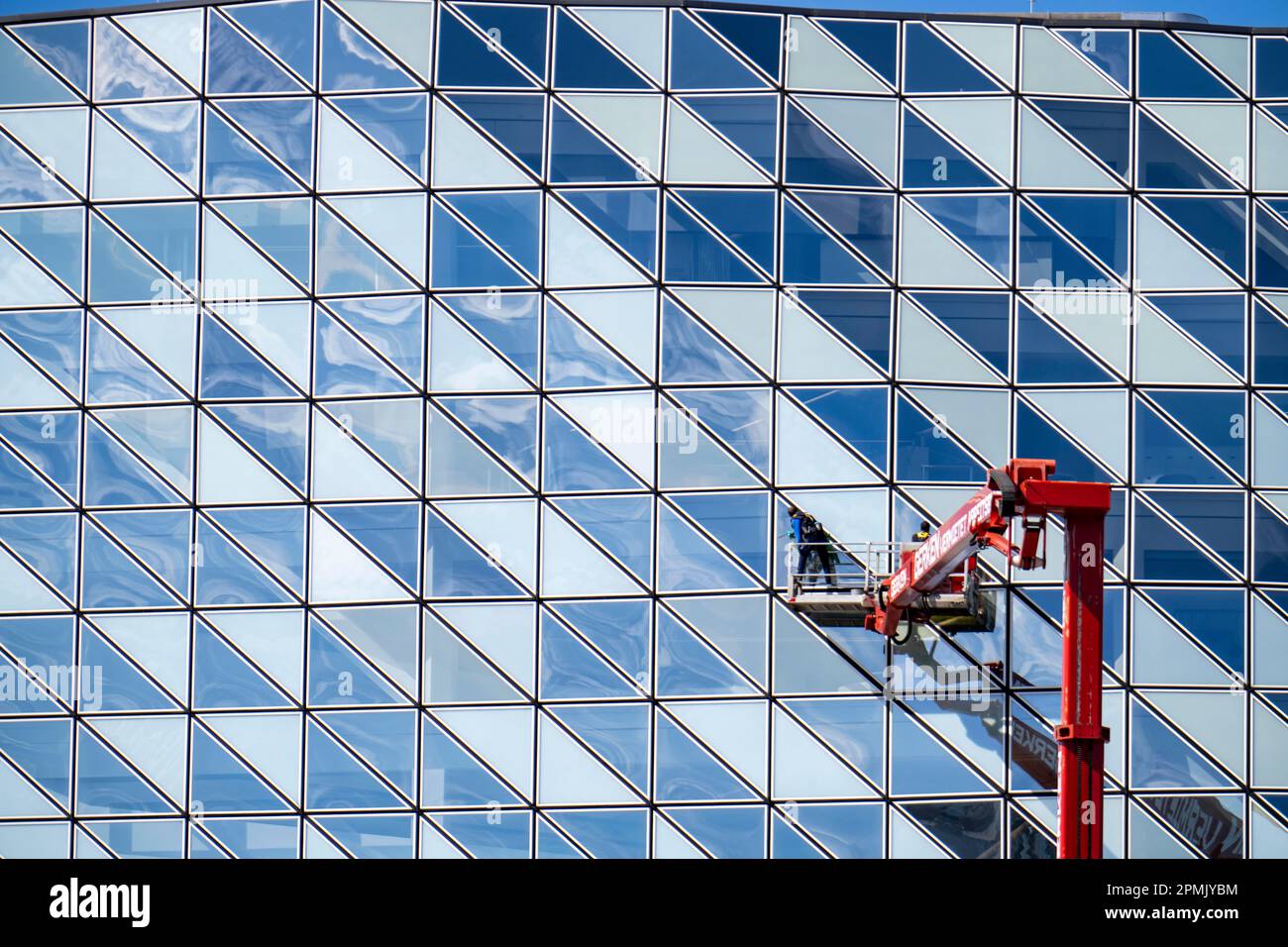 Building cleaners clean window panes, clean a facade, truck working ...