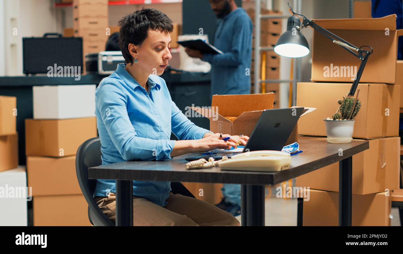 Female owner doing quality control before shipping goods in cardboard ...