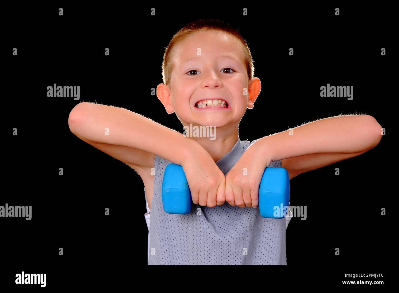 A Young boy fitness training with weights Stock Photo - Alamy