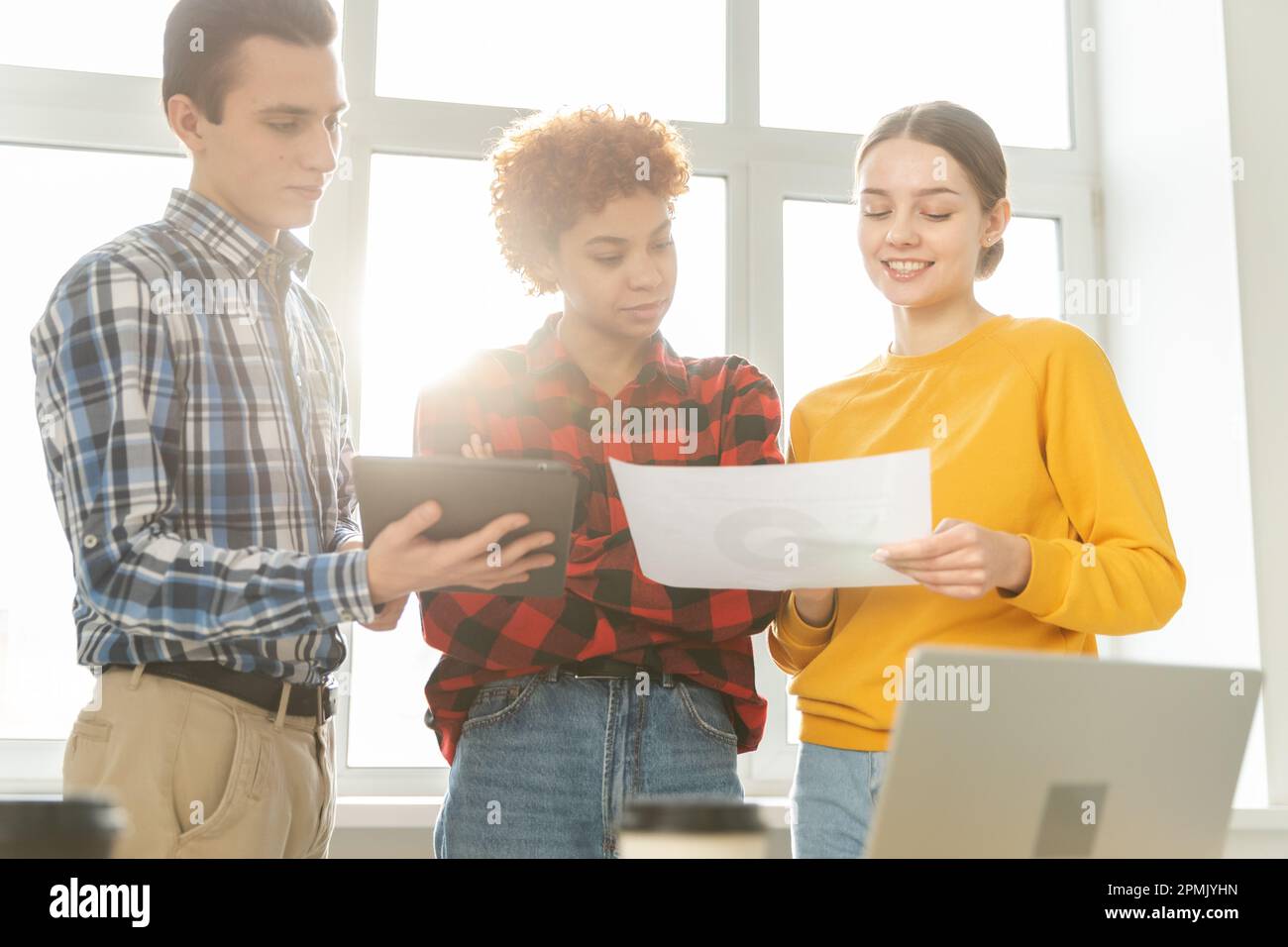 Teamwork brainstorm young professional team concept. Happy multiracial coworkers cooperating ...