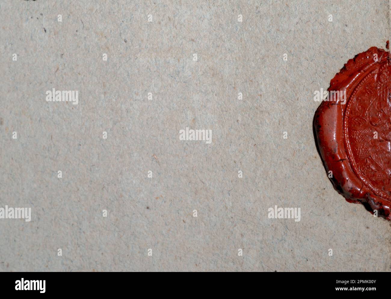 A blank weathered paper background with a part of a red seal visible ...