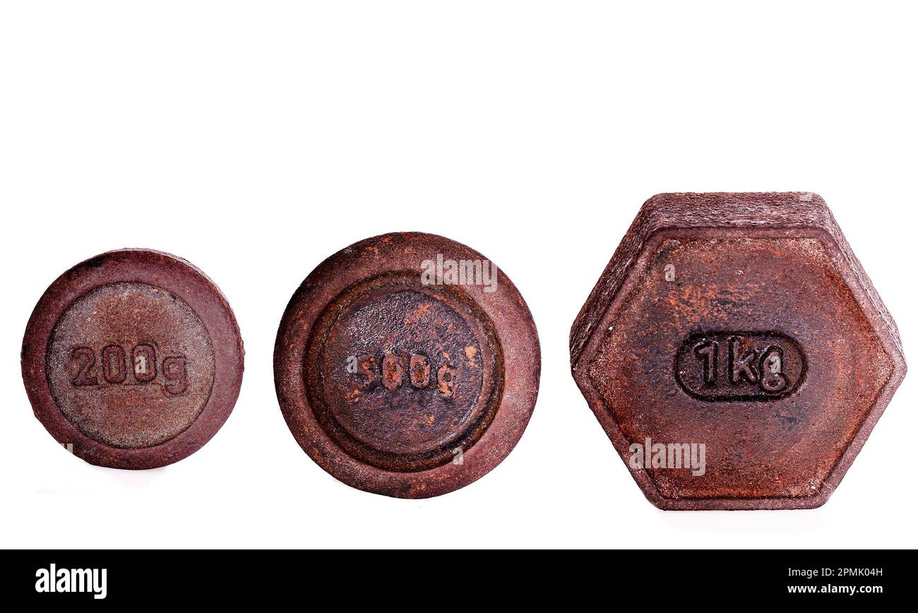 Close up of three rusty standard metric weights made of iron for ...