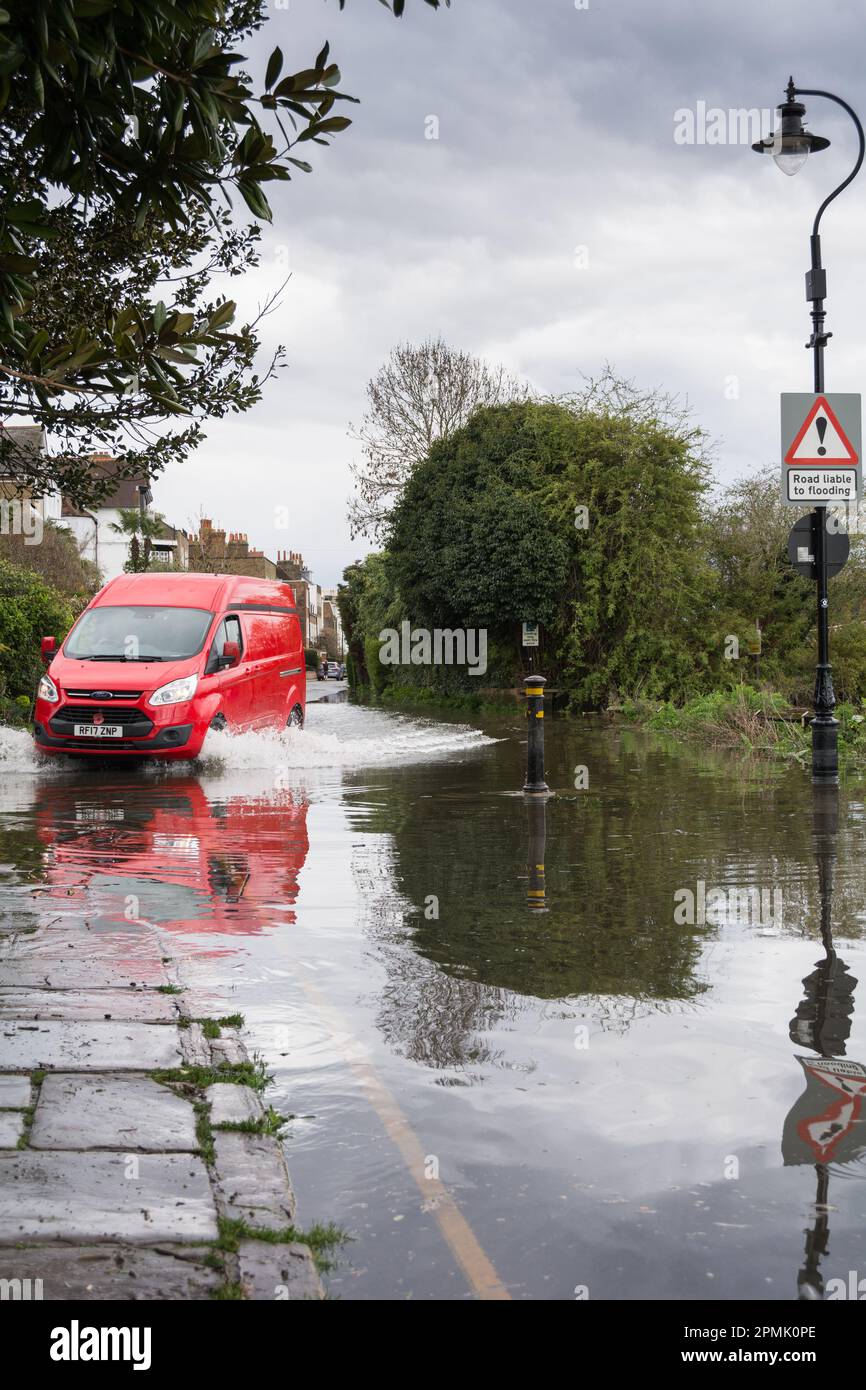 A red delivery van battling through high tide flooding on Chiswick Mall ...