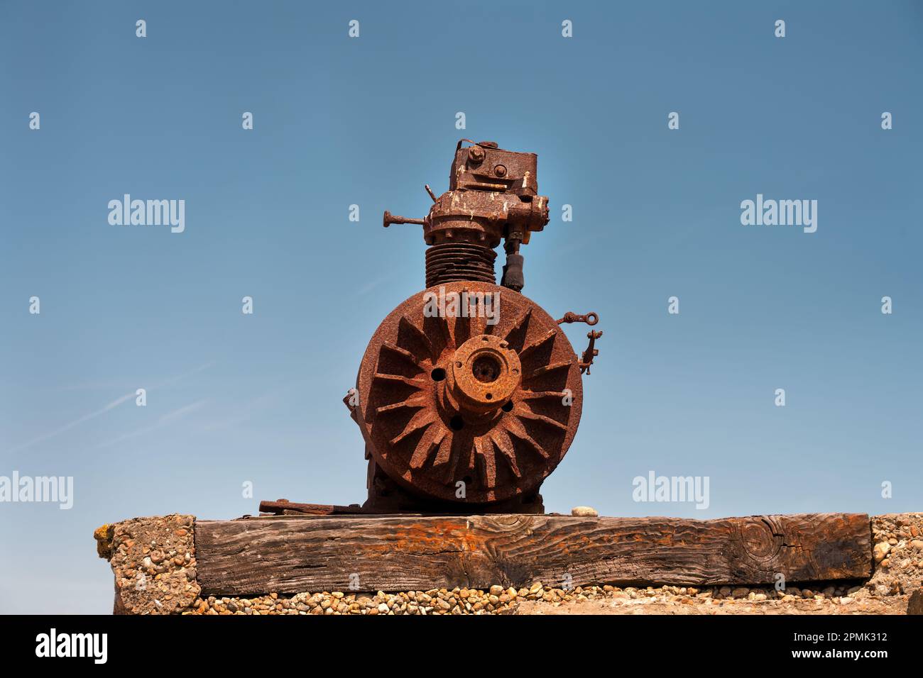 Rusty metal cog wheel on a wooden and concrete base Stock Photo - Alamy