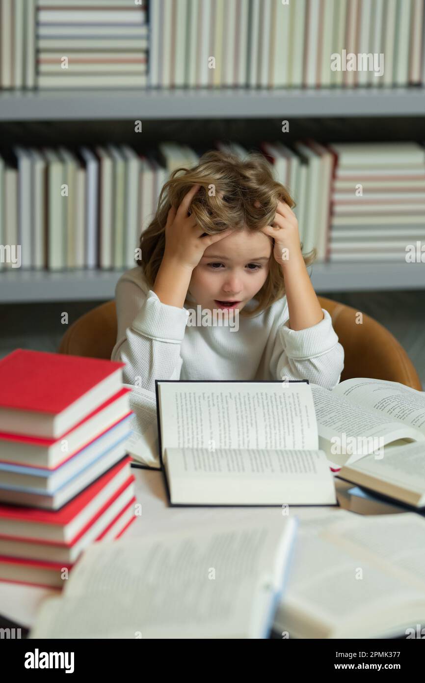 Intellectual child, clever pupil. Child boy doing homework on desk in ...