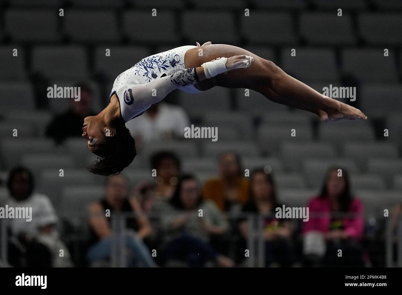 California's eMjae Frazier competes on the uneven parallel bars during ...