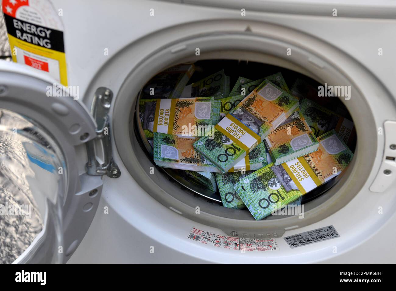 Washing machines filled with replica Austalian money are seen during a ...