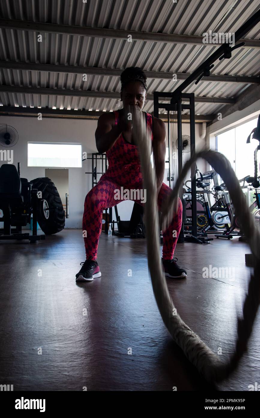 Woman doing training with naval rope. Abdominal strengthening and ...