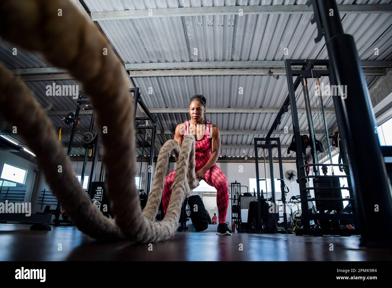 Woman doing training with naval rope. Abdominal strengthening and ...