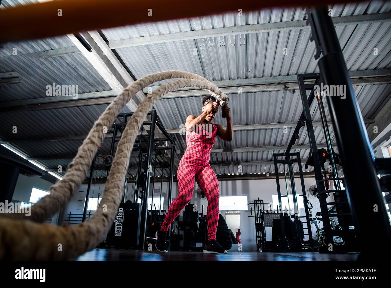 Woman doing training with naval rope. Abdominal strengthening and ...