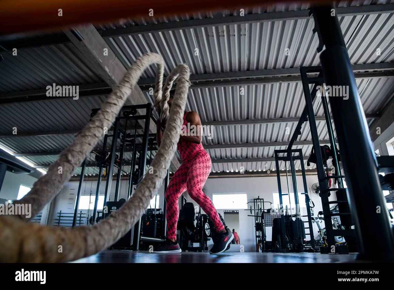 Woman doing training with naval rope. Abdominal strengthening and ...