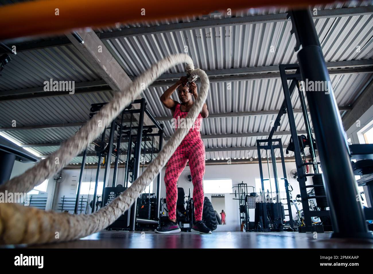 Woman doing training with naval rope. Abdominal strengthening and ...