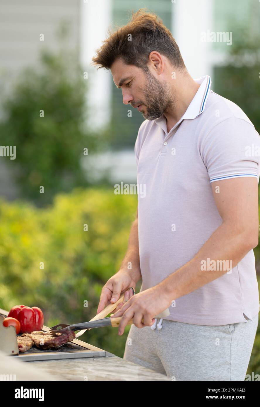 Grill cook. Chef with BBQ cooking tools. Barbecue and grill. Picnic and ...