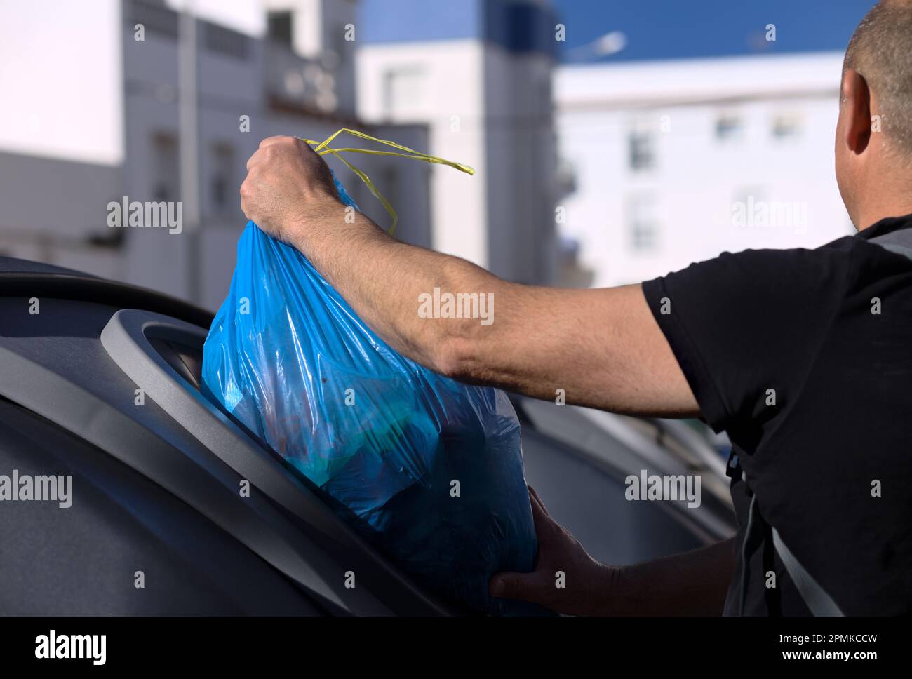 Man person dumping a rubbish garbage bag sack in public waste litter ...