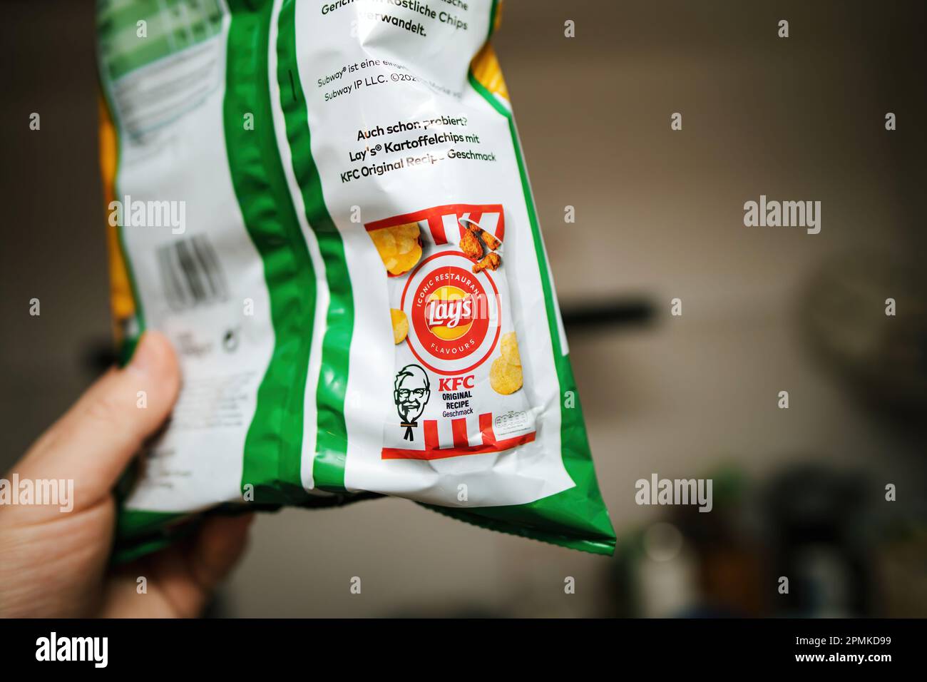 Frankfurt, Germany - Mar 6, 2023: A person holds a yellow packet of KFC ...