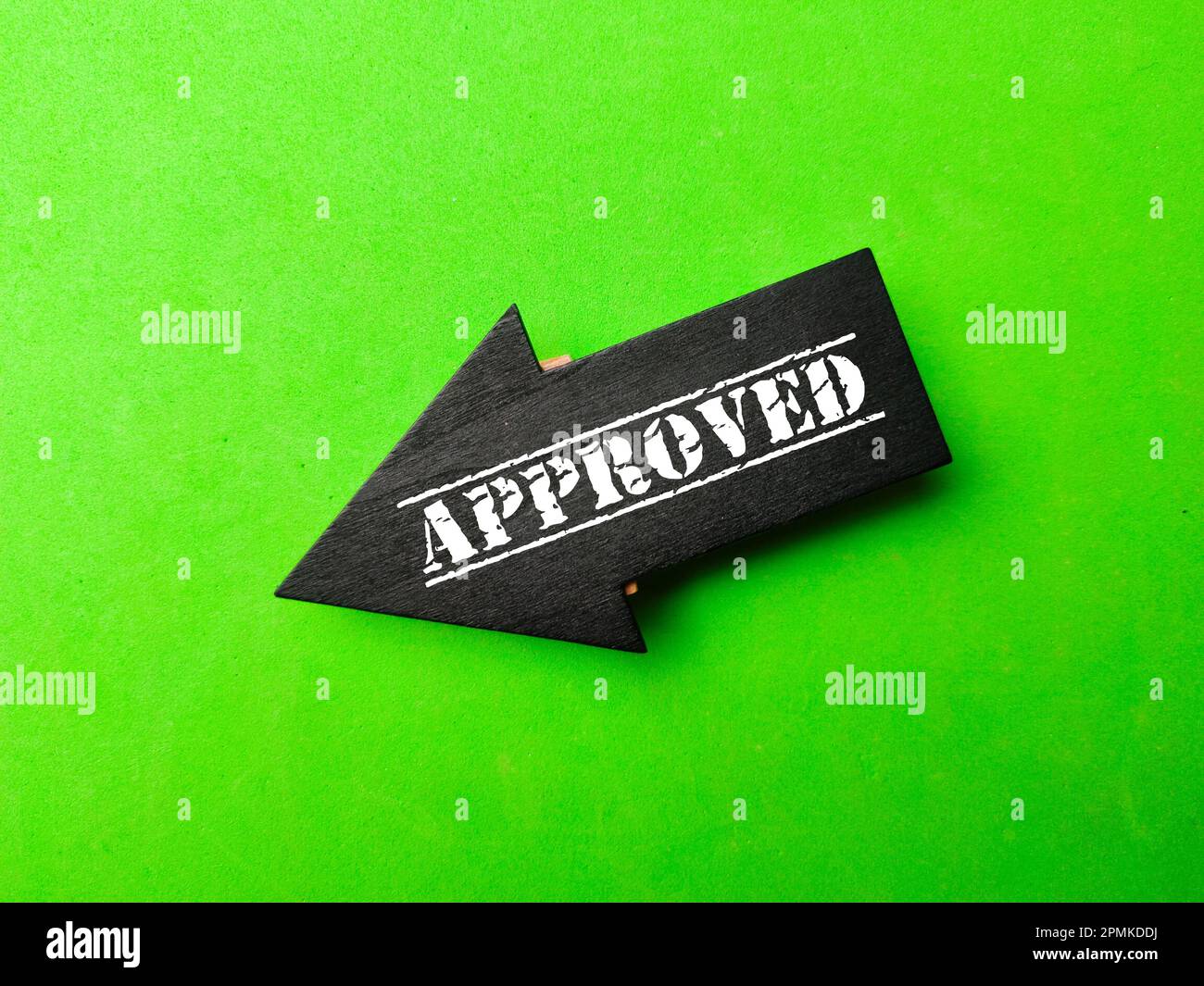 Wooden black arrow with the word APPROVED on a green background ...