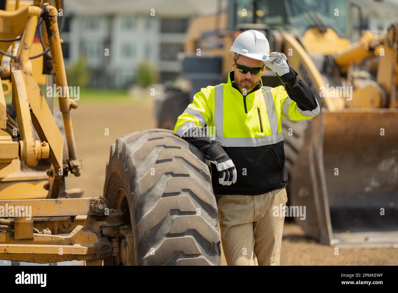 Worker with bulldozer on site construction. Man excavator worker ...
