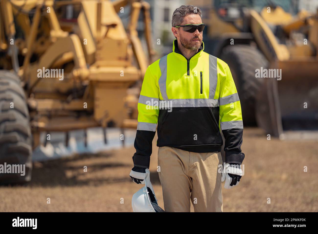 Worker with bulldozer on site construction. Man excavator worker ...