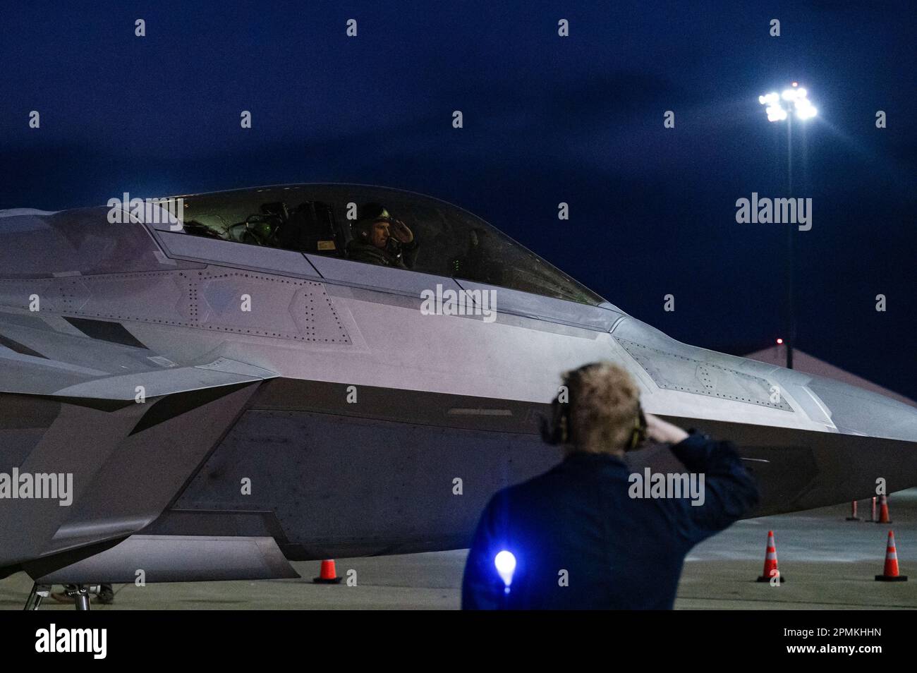 A crew chief assigned to the 94th Fighter Squadron salutes the pilot of ...