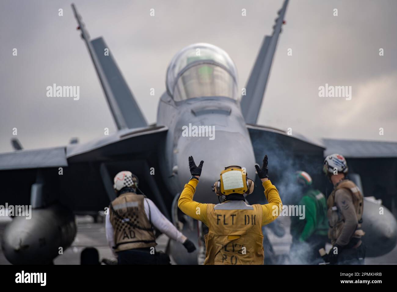 230411-N-DU622-1044 PHILIPPINE SEA (April 11, 2023) A U.S. Navy Sailor directs an E/A-18G ...