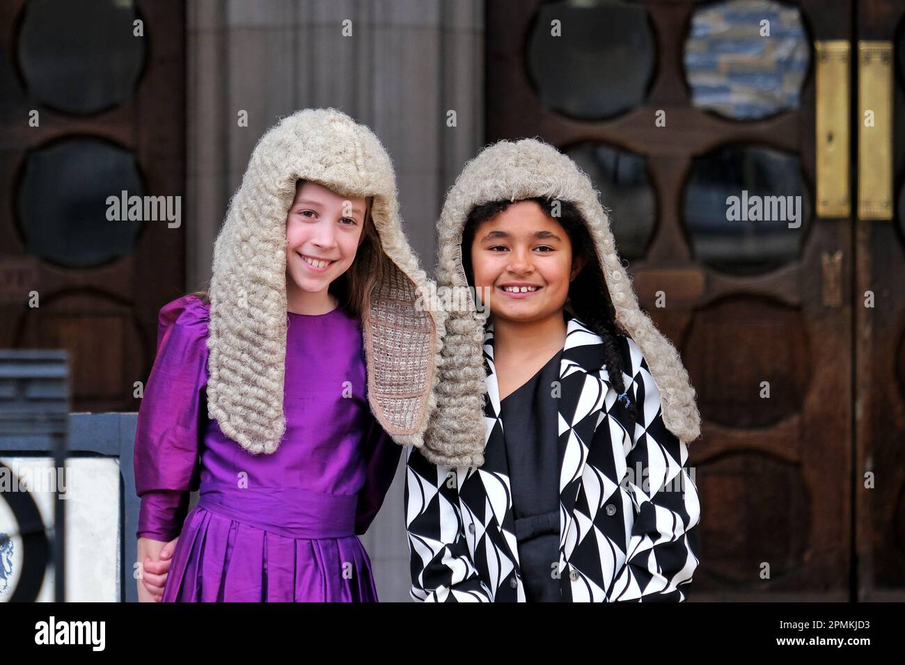 Two children pose in full bottom (judges) wigs outside the Royal Courts ...