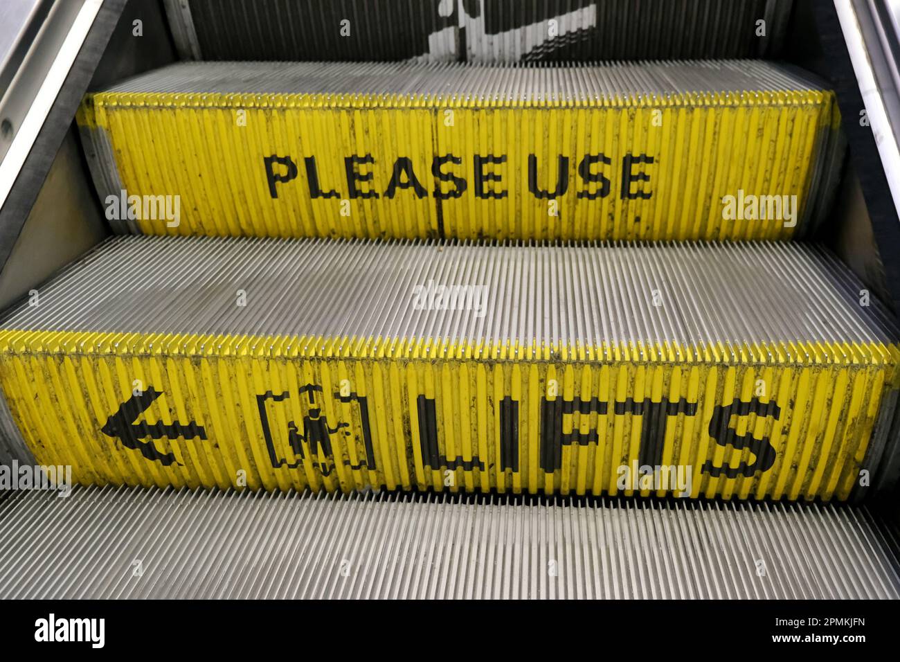 London, UK. An escalator at King's Cross Station advising passengers to ...